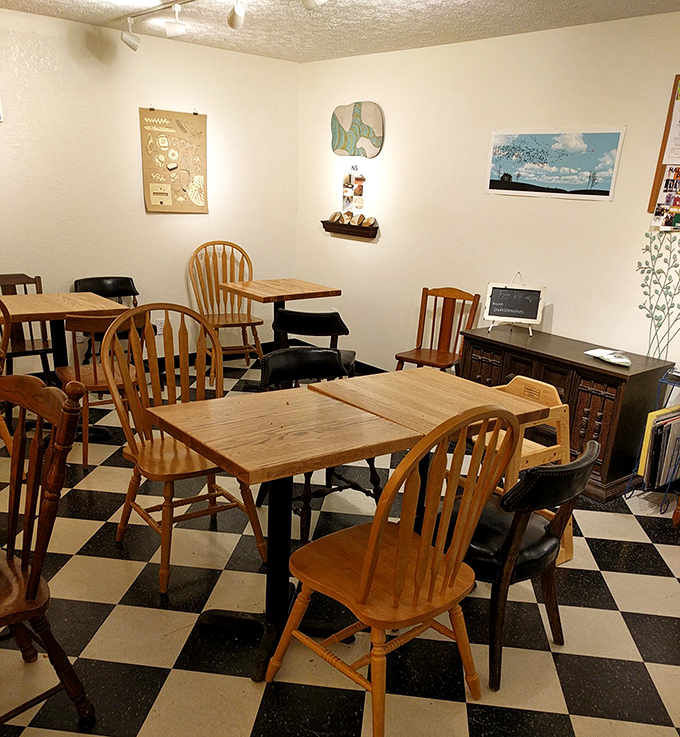 Classic black and white checkered floors, wooden chairs, and simple decor create that rare atmosphere where time slows down just enough to savor every bite.