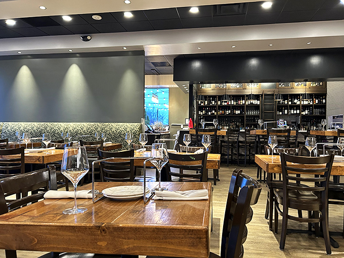 Wine glasses await their perfect pairing in Basil's contemporary dining room, where rustic wood meets modern design sensibilities.