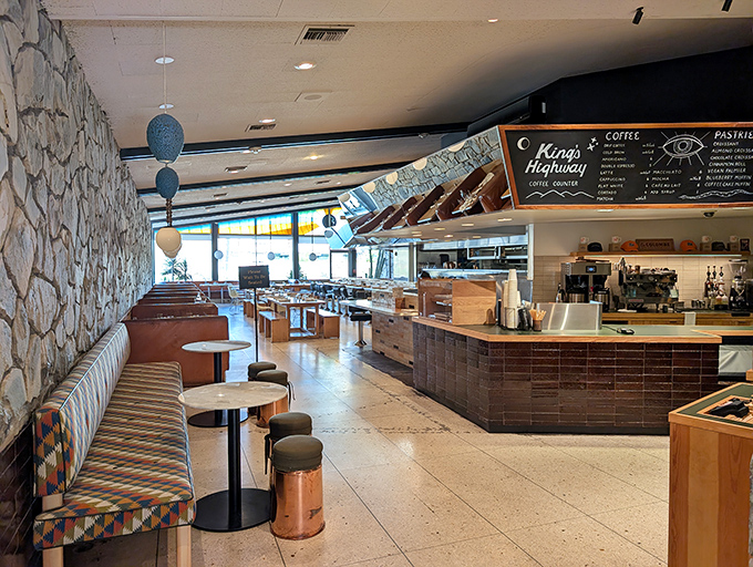 The interior blends roadside Americana with desert chic &ndash; terrazzo floors, stone walls, and colorful banquettes that say "stay awhile" in the universal language of comfort.