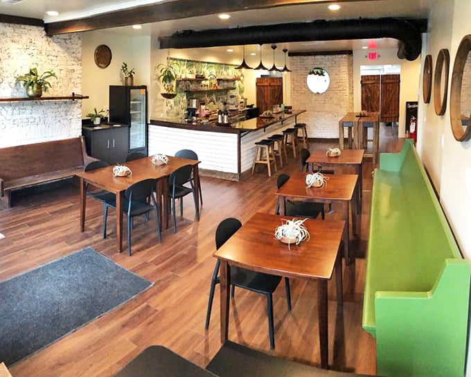 Exposed brick walls meet wooden beams in this cozy interior that somehow manages to feel both rustic and modern&mdash;like a hug from your coolest friend.