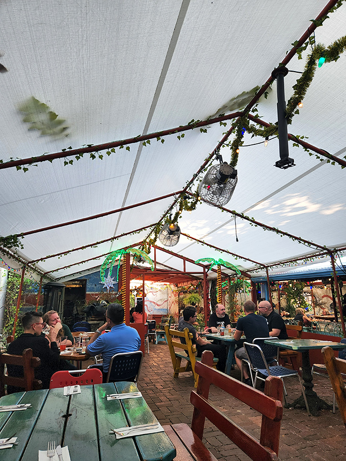 Nature meets nostalgia in Silk City's enchanted garden seating area, where twinkling lights and lush greenery transform ordinary meals into magical experiences.