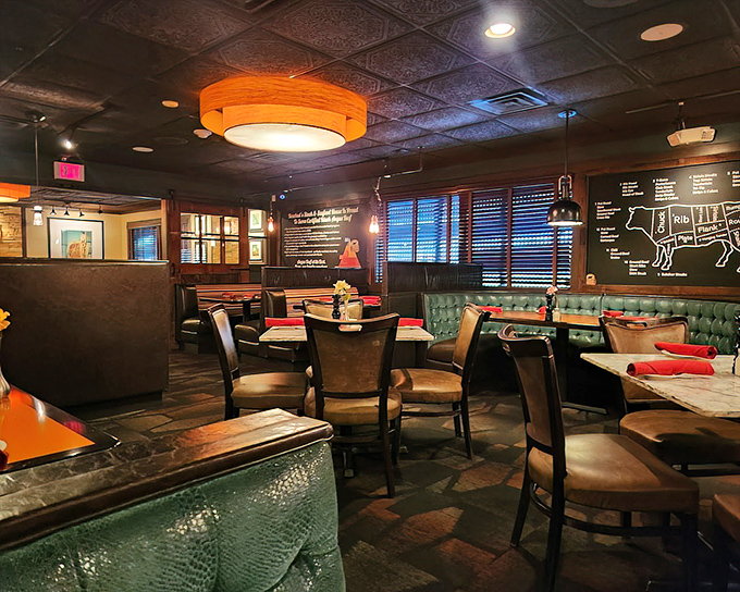 Green leather booths and warm lighting create that perfect steakhouse ambiance where everyone looks good and the conversation flows.