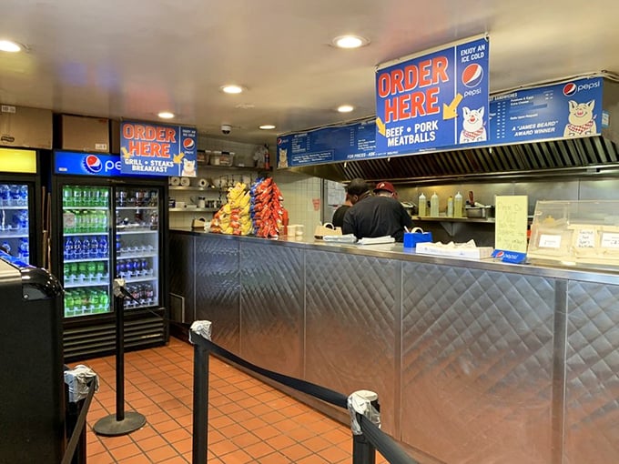 No-frills counter service where the magic happens. The stainless steel workspace gleams like the engine room of a sandwich-making battleship.