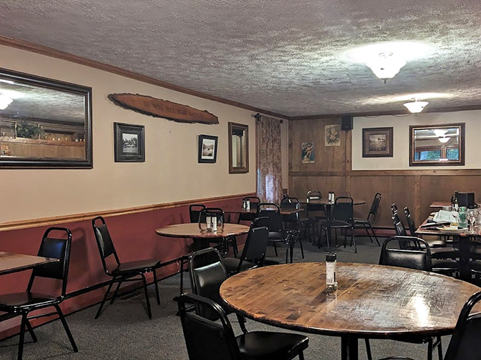 Round wooden tables and wood-paneled walls—this isn't trendy design, it's the authentic comfort that never needed Instagram to validate its appeal.