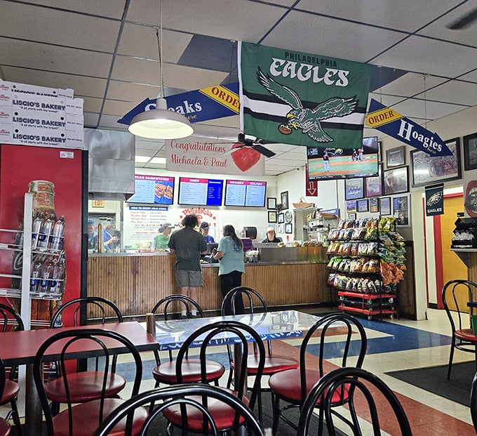 Eagles pride flies high inside, where the ordering counter beckons with promises of Philadelphia flavor. The pilgrimage spot for sandwich devotees.