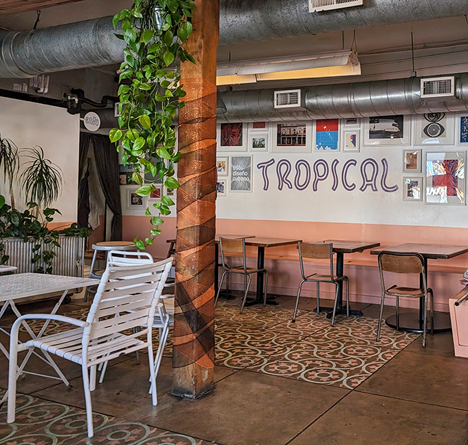 Wooden pillars wrapped with climbing plants create a homey vibe inside, where patterned tiles and simple furniture invite you to linger over coffee.