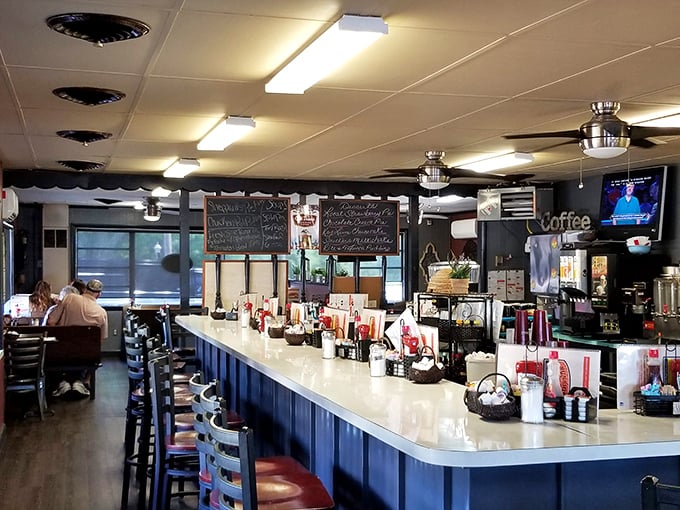 The classic diner counter beckons with its blue-and-cream color scheme &ndash; a front-row seat to the breakfast theater that unfolds daily.