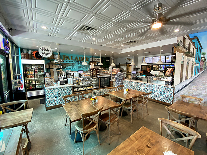 Inside, those gorgeous blue-patterned tiles and warm wood tables create the perfect backdrop for the sandwich drama about to unfold on your plate.