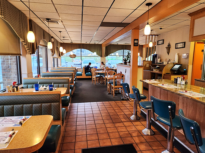 Classic diner ambiance with booths that have cradled generations of hungry patrons. The pendant lights cast that golden "you're home now" glow.