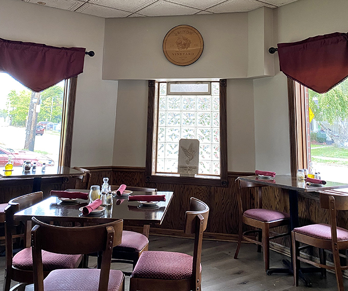 Warm wood paneling and burgundy accents create that "Nonna's dining room" vibe&mdash;minus the plastic-covered furniture.