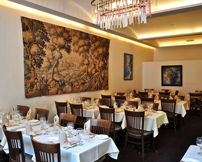 White tablecloths and that stunning tapestry create the perfect backdrop for the food drama about to unfold.