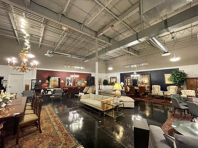 High ceilings and thoughtful displays transform this former industrial space into a gallery where every furniture grouping tells a potential story.