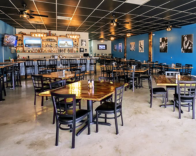 The dining room's blue walls and wooden tables create that perfect sweet spot between casual and special occasion. Country music legends silently approve from their frames.