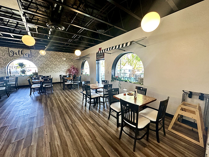 Sunlight streams through arched windows, illuminating a dining space where comfort meets style. The kind of place where conversations flow as easily as the coffee.