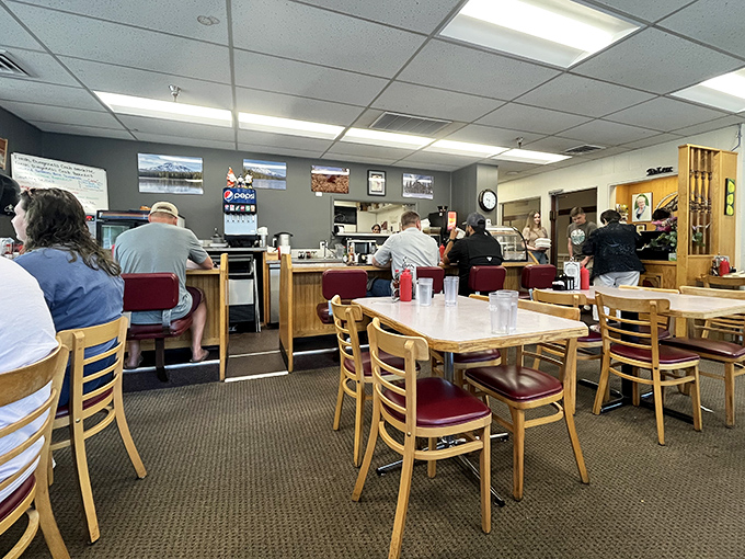 The breakfast battlefield where decisions are made and friendships tested&mdash;wooden chairs await while the counter beckons to solo diners and coffee enthusiasts.