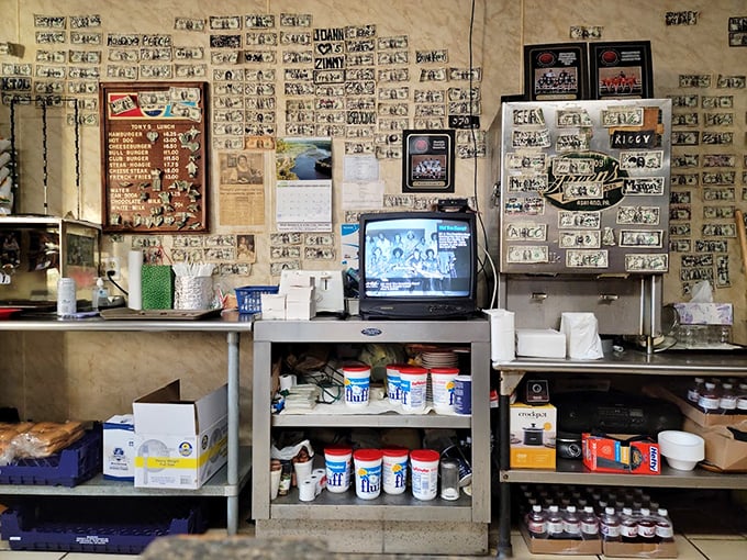 Dollar bills wallpaper the interior like a currency museum of satisfied customers past. Each signed bill tells a story of screamer-induced happiness.