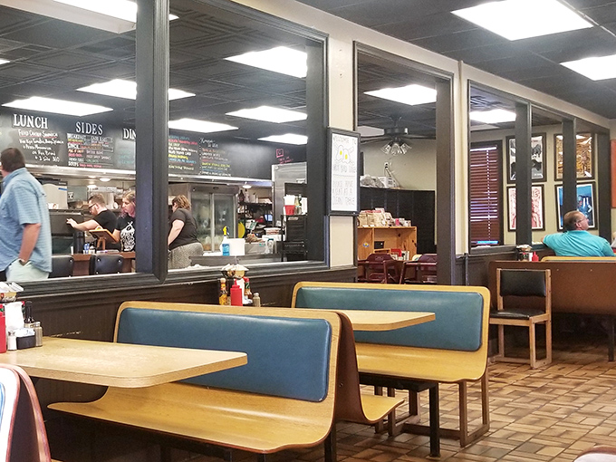 Classic diner booths await hungry patrons while the open kitchen buzzes with activity. This is breakfast theater at its finest, where every sizzle tells a story.