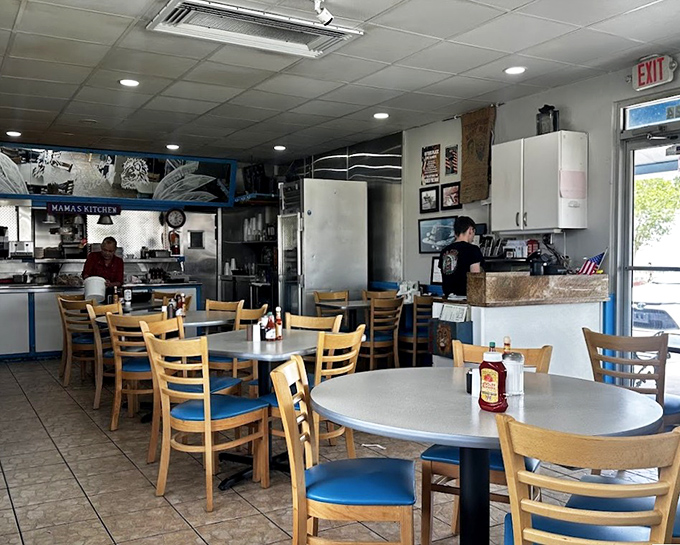Simple wooden chairs and classic diner tables create an unpretentious atmosphere where the food, not the decor, takes center stage.