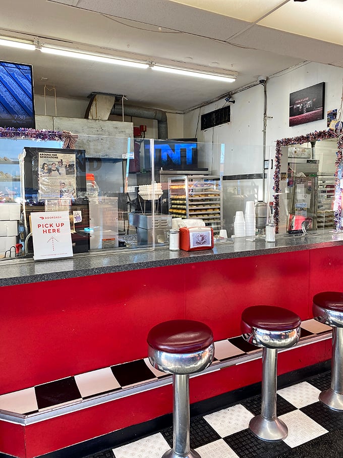 Classic diner-style counter stools invite you to perch while watching donut magic unfold behind the scenes.