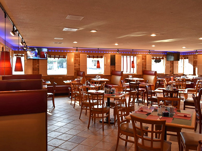 Blue lighting casts a cozy glow across the dining room, where every booth promises the comfort of home with none of the dishes.