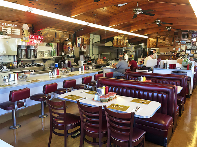 Those burgundy booths have heard more stories than a bartender at closing time, and they're still comfortable.