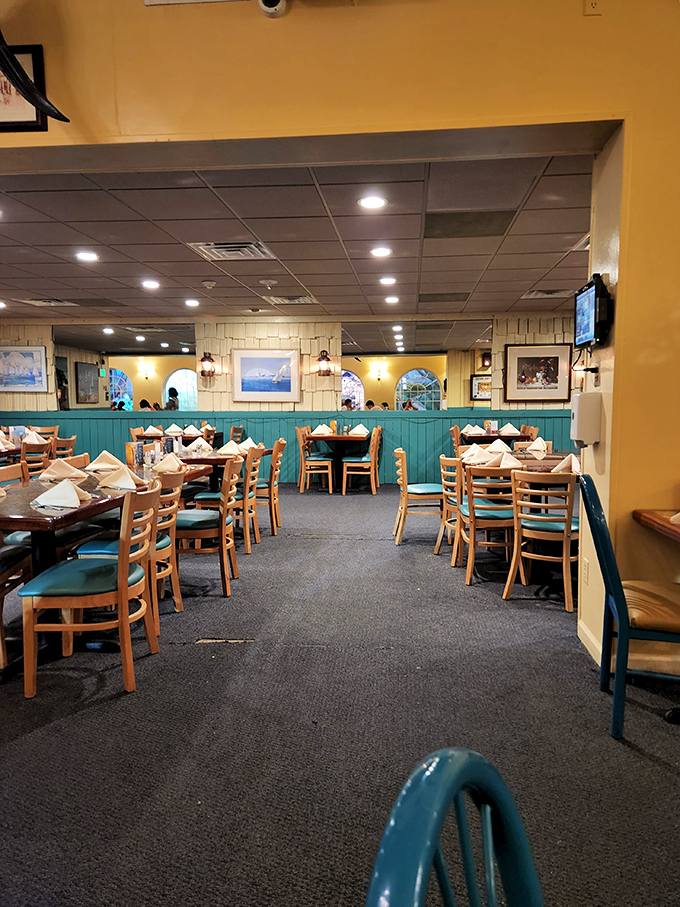 Teal wainscoting and warm wood tones create that perfect "coastal comfort" vibe – like a beach house where calories don't count.