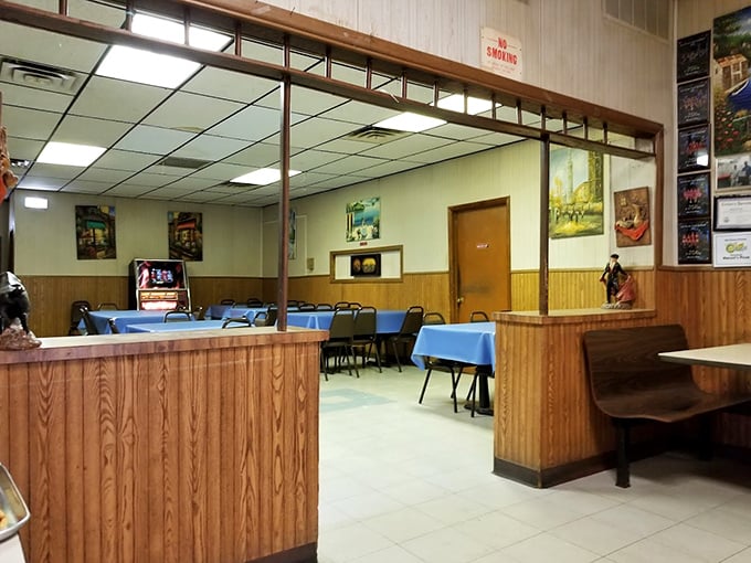 Step inside and time stands still. Wood paneling, blue tablecloths, and fluorescent lighting create the perfect stage where pizza, not d&eacute;cor, plays the starring role.