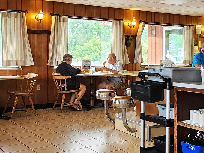 Wood paneling that whispers "comfort food ahead" while those classic diner chairs have supported generations of satisfied customers.
