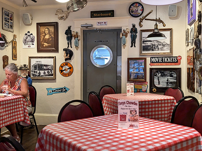 The nautical-themed interior feels like dining inside a sea captain's personal scrapbook—complete with porthole door and enough maritime memorabilia to outfit a small museum.