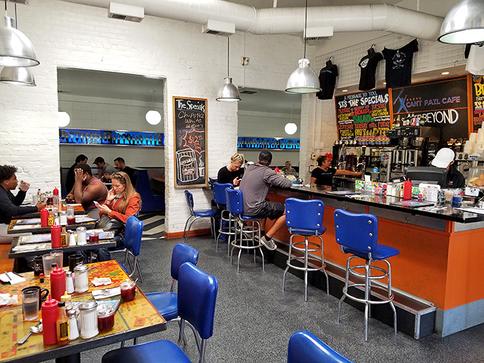 Blue chairs, white walls, and colorful chalkboards create the perfect backdrop for both serious eating and casual conversation.