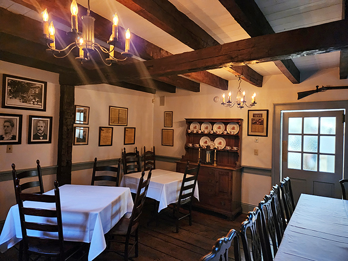 Exposed beams, white tablecloths, and period-appropriate chandeliers create a dining room where you can almost hear the whispers of history between bites.