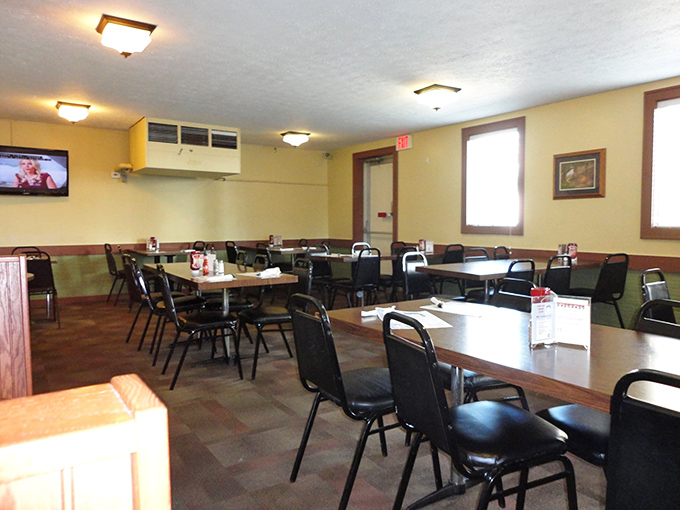 Simple tables, practical chairs, and yellow walls create the perfect stage for the star attraction. In the theater of chicken, the dining room is deliberately understated.