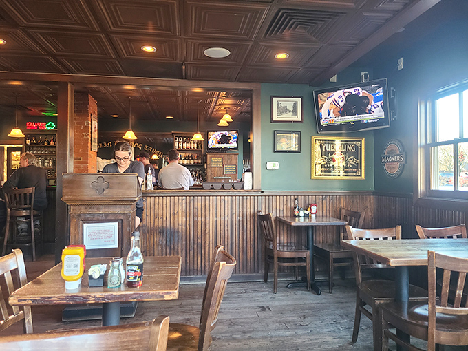 Step inside and you're transported to a proper Irish pub, where wooden wainscoting meets sage green walls under ornate tin ceiling tiles.