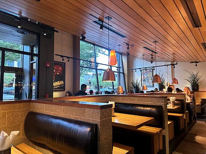 Warm wooden ceilings and copper pendant lights create that rare atmosphere where hipsters and grandparents feel equally at home. Architectural comfort food.