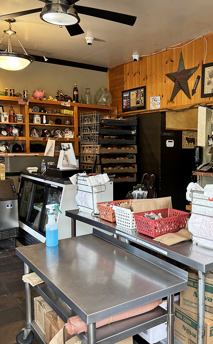 Inside, every inch counts. Wood paneling, metal shelving, and that rustic star create a cozy smokehouse vibe that says "serious barbecue happens here."