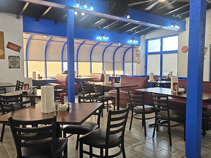 Blue support beams frame a dining room where comfort meets nostalgia, creating the perfect backdrop for food that speaks straight to the soul.