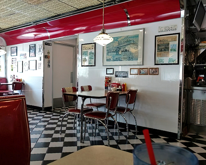 Classic red vinyl meets chrome in this booth where countless elbows have rested and coffee cups have clinked since before smartphones ruined breakfast conversation.