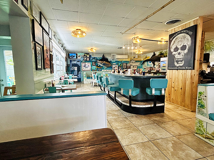 Turquoise booths, mounted fish, and that signature skull logo—this isn't interior design, it's Keys storytelling with comfortable seating.