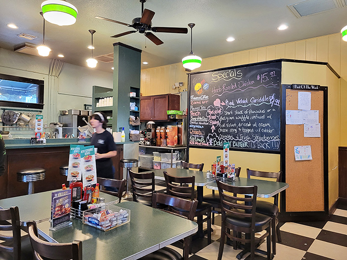 Inside, the classic diner vibe hits all the right notes—checkered floors, green-trimmed lights, and a specials board that reads like a love letter to hungry patrons.