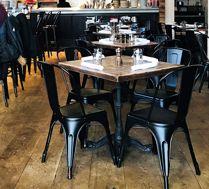 Industrial chic meets sandwich sanctuary. These metal chairs have witnessed countless "first bite" faces&mdash;that universal expression of cheesesteak enlightenment.