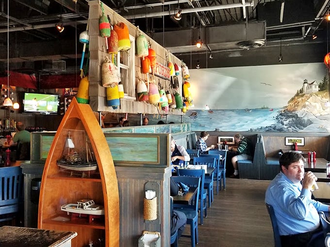 Colorful buoys dangle from the ceiling like maritime Christmas ornaments while a coastal mural transports diners from shopping center to seaside in seconds.