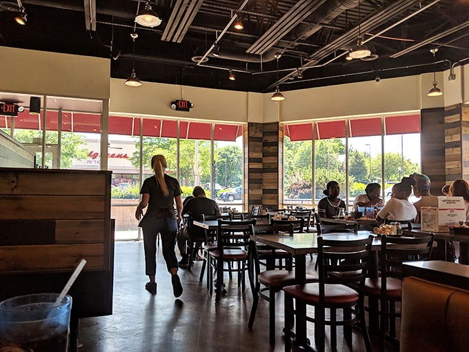 Morning light streams through windows as diners settle into the warm wood-paneled interior, where breakfast dreams come true.
