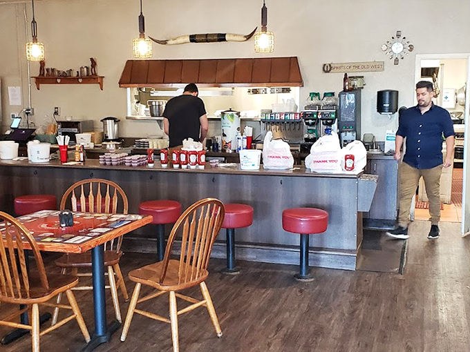 Inside, the counter seating offers front-row tickets to the breakfast show, where wooden chairs and red vinyl stools have witnessed countless coffee refills and satisfied smiles.