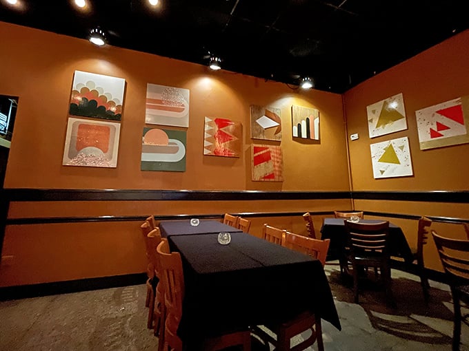 Warm orange walls adorned with modern art create the perfect backdrop for cheese-induced euphoria&mdash;like dining inside a cozy sunset with better seating.