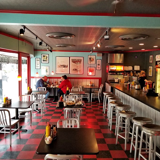 Classic red and black checkered floors set the stage for culinary nostalgia, where every stool at the counter has witnessed countless coffee refills and life stories.