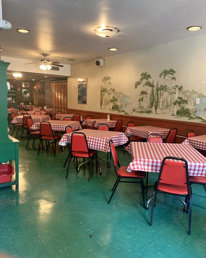 Classic red-checkered tablecloths and mint green floors create a time capsule of mid-century Italian-American dining, where memories are made between bites.