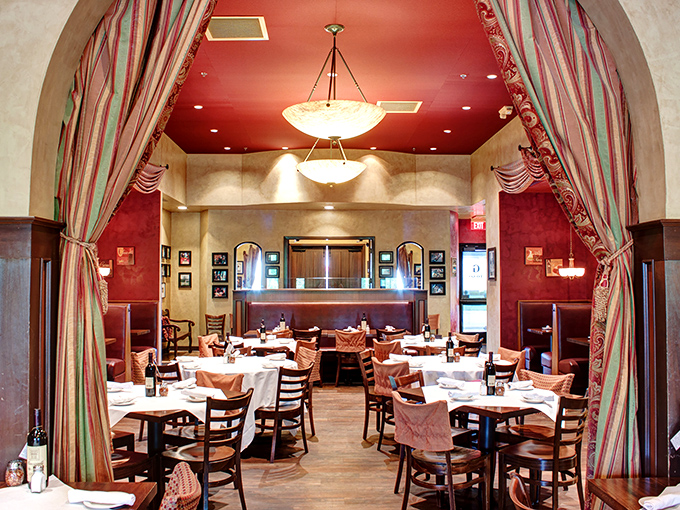 Step through the archway into a world where red ceilings, elegant drapery, and white tablecloths create the perfect backdrop for carb-laden love affairs.