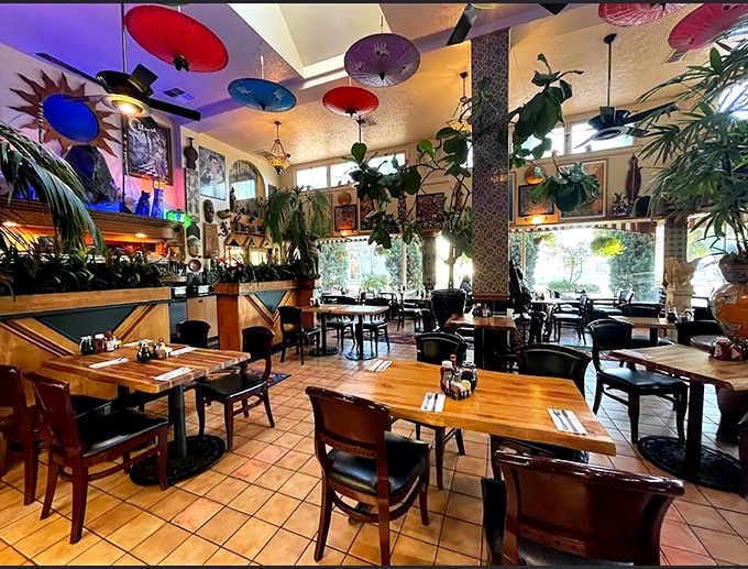 Colorful parasols dance overhead while plants cascade from every corner, creating a dining jungle where food and foliage live in perfect harmony.