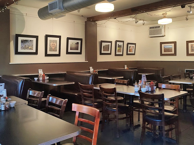 Cozy booths, warm wood tones, and local artwork create that perfect "stay awhile" atmosphere. Like a breakfast hug in architectural form.