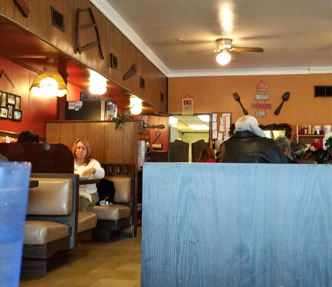 Wood paneling and cozy booths create that classic diner atmosphere where conversations flow as freely as the coffee.